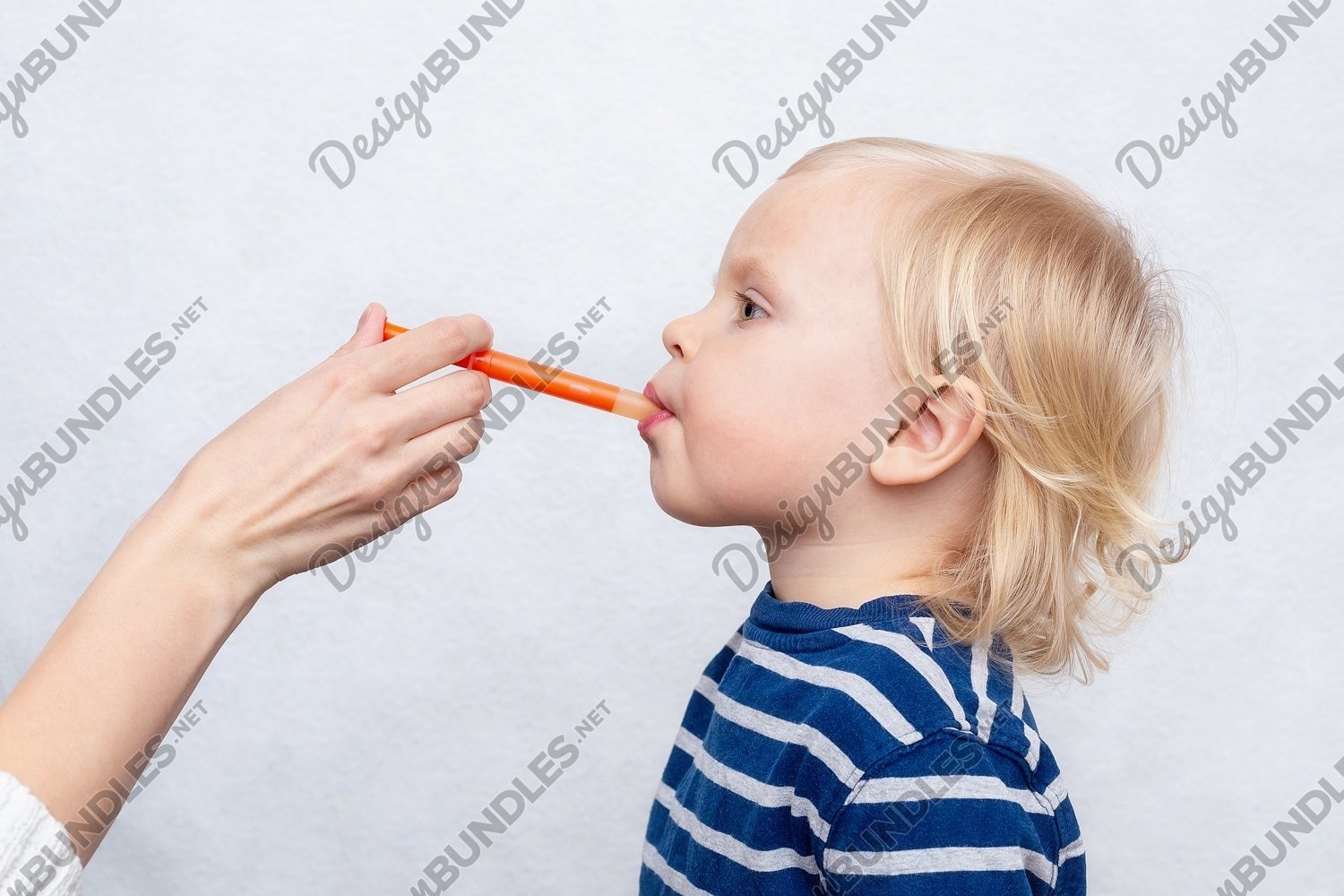Photo of a boy gets kids medicine with a syringe