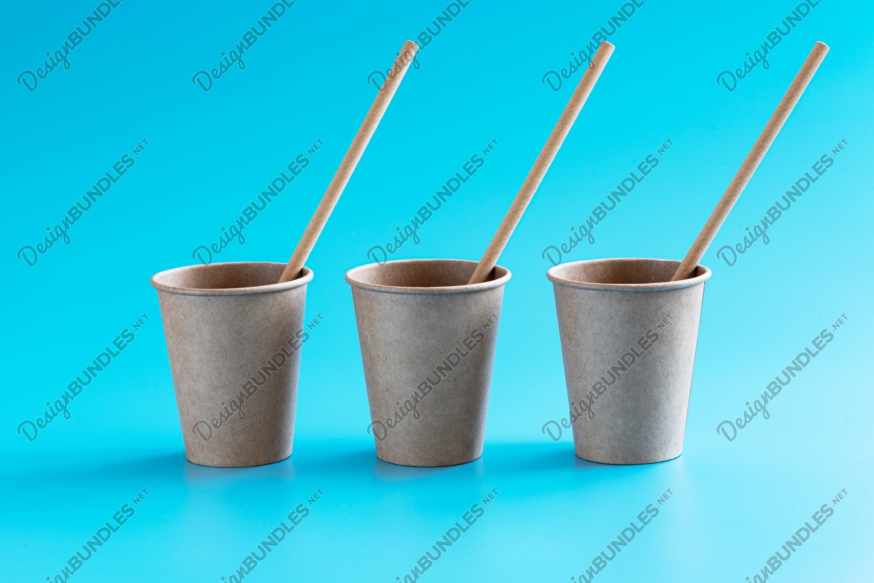 Three disposable brown paper cups with paper straws in a row (854293 ...