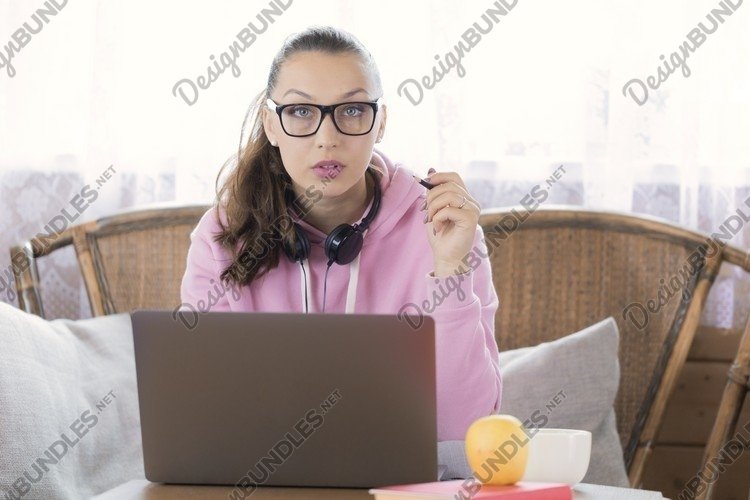 Pretty brunette girl works remotely with laptop computer (1006729 ...
