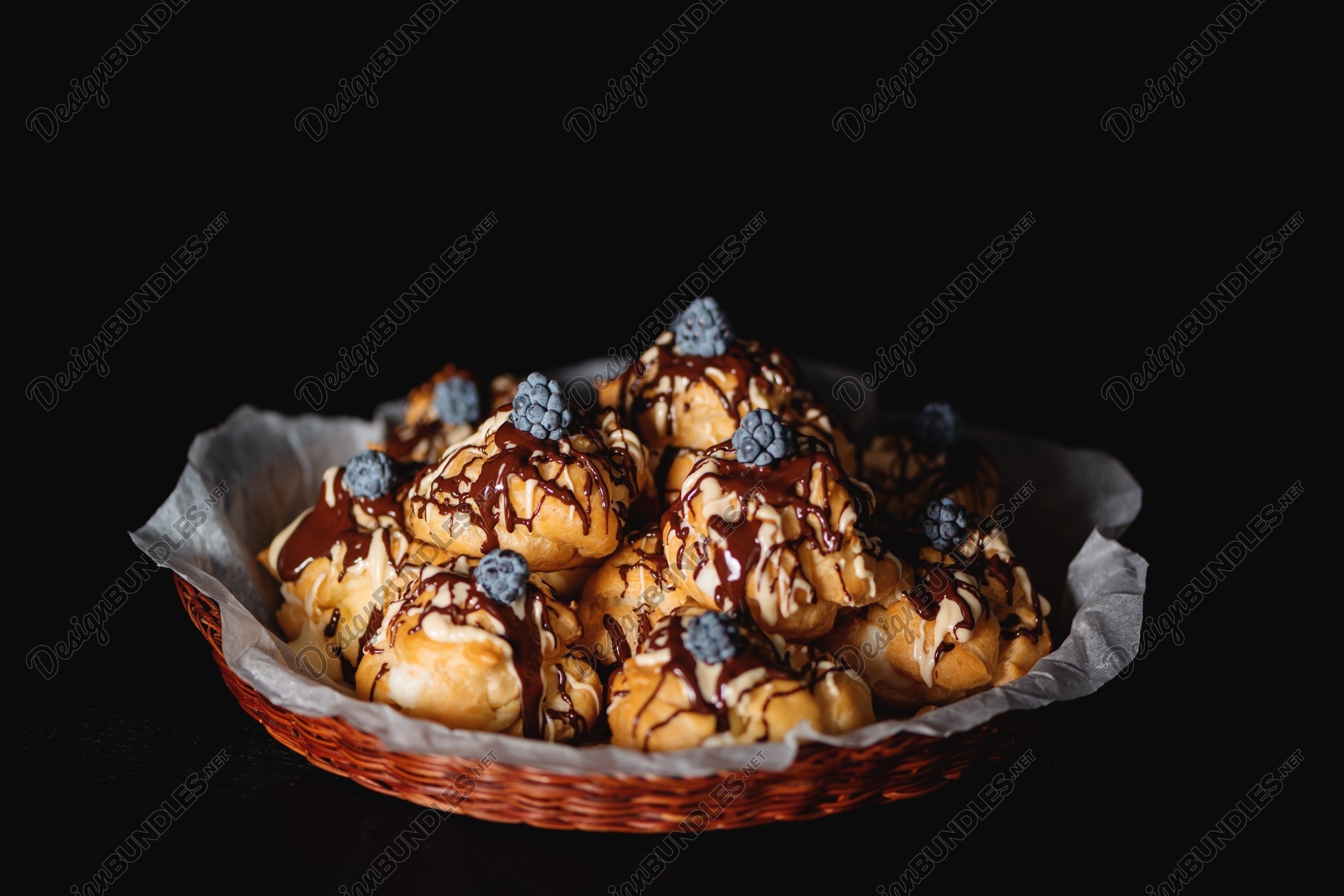 Homemade profiteroles with custard cream in wicker basket (914922 ...