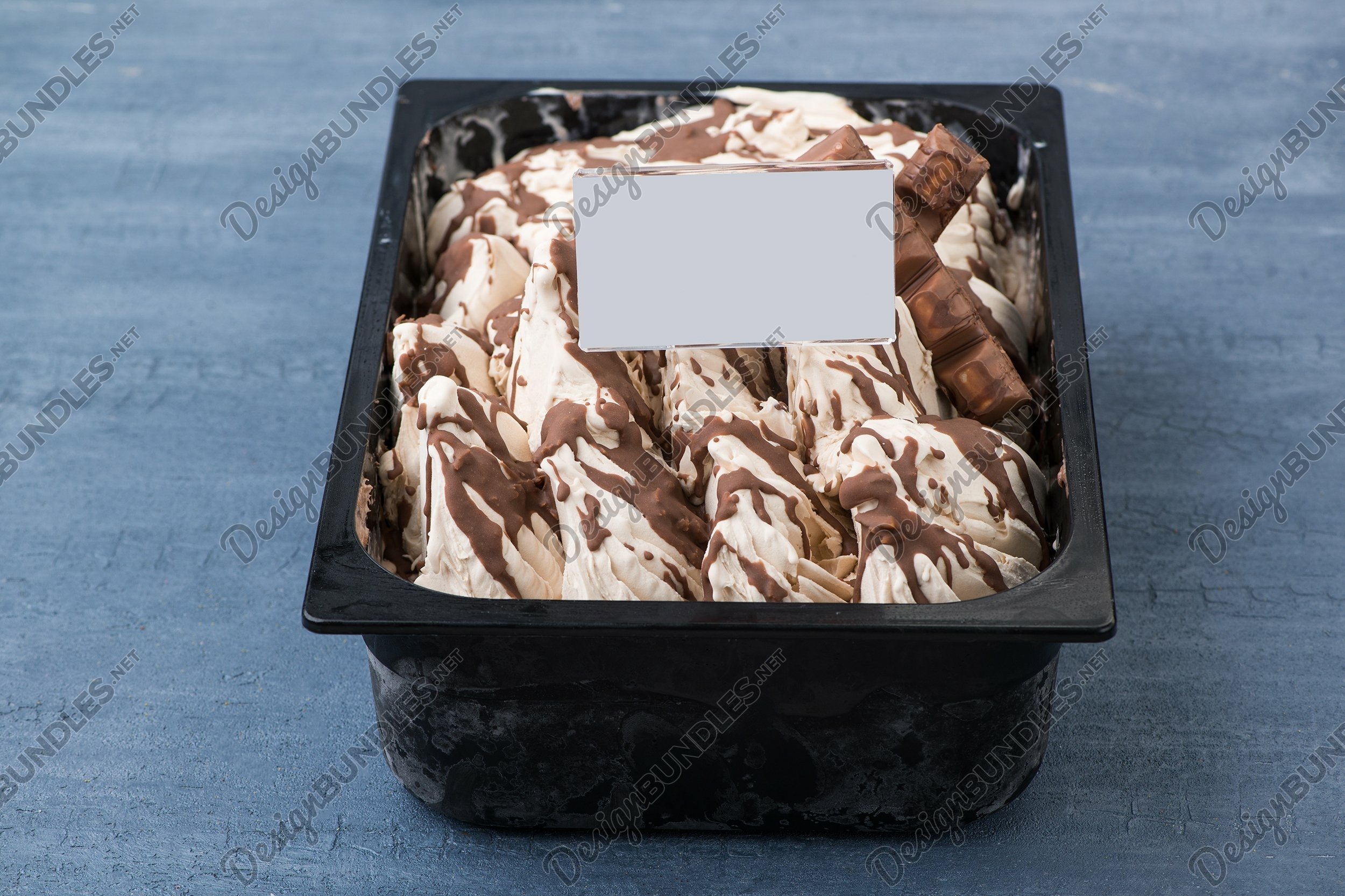 Ice cream in a plastic container with a price tag on a blue (1272854 ...