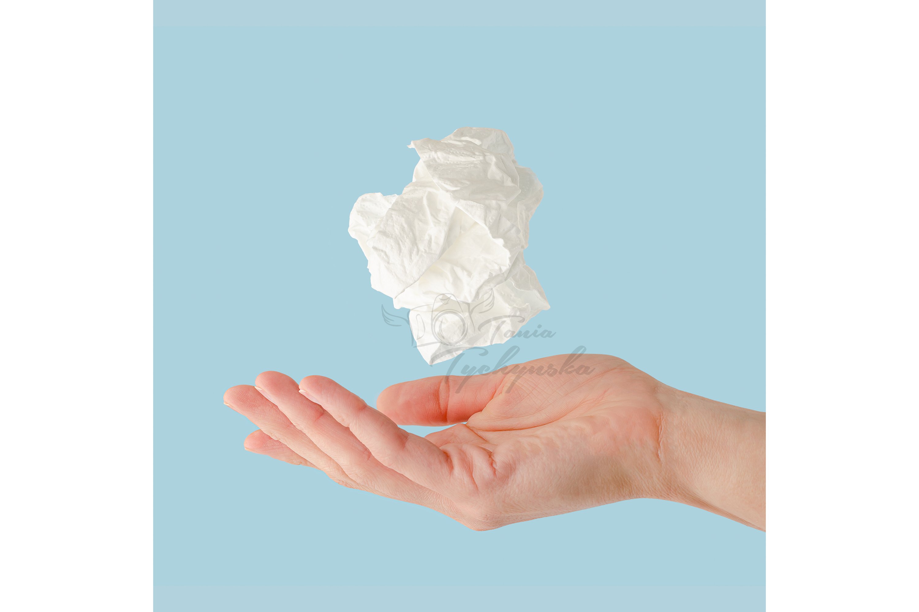 Crumpled handkerchief flying over female hand on blue (660116 ...