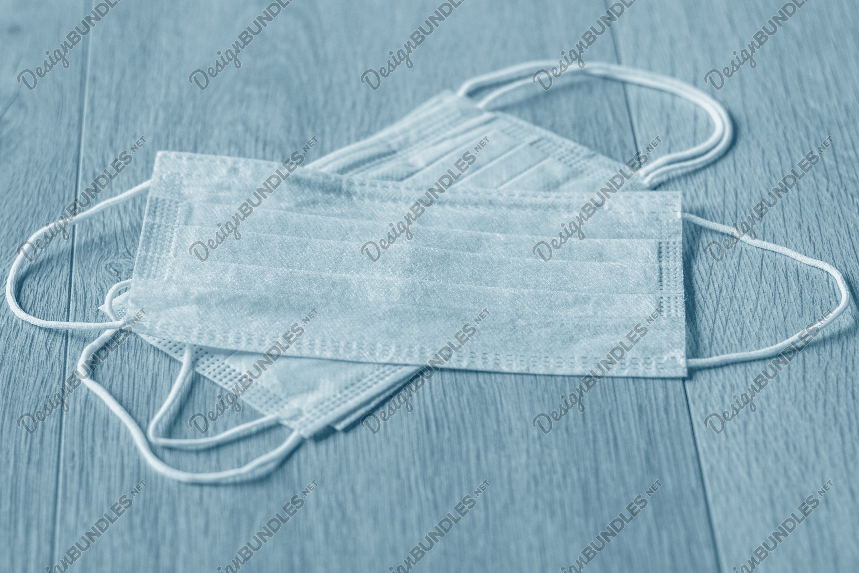 Blue surgical masks on a classic blue wooden background. (590203 ...
