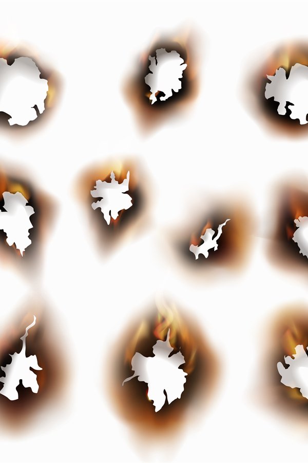 Singed paper. Burnt round holes flame collection, parchment