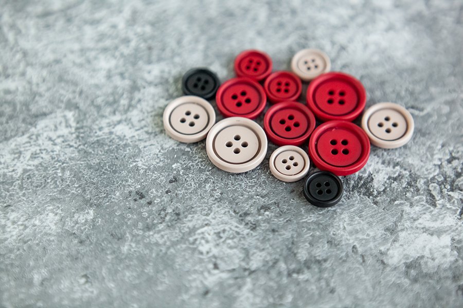 Red fashion buttons on concrete background (684335)