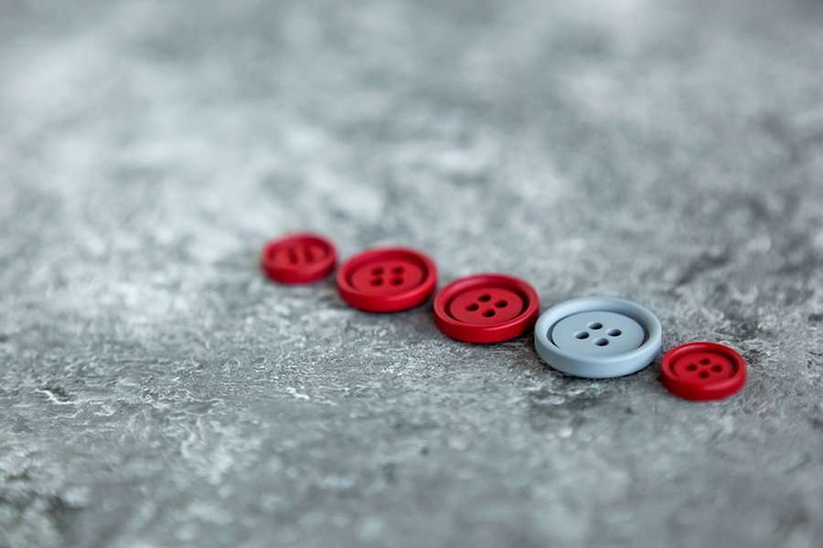 Red fashion buttons on concrete background (684336)