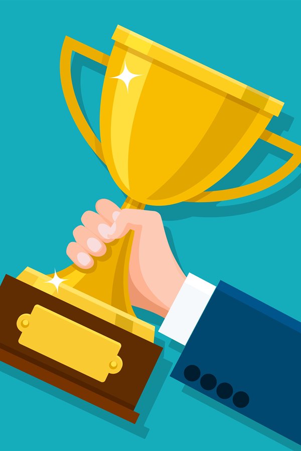 Business hand holding trophy