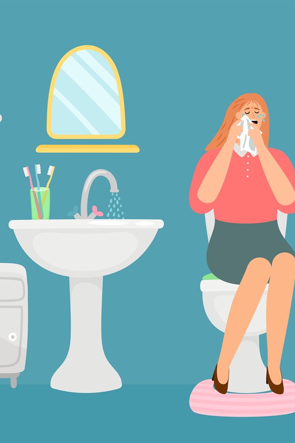 Woman crying in toilet room