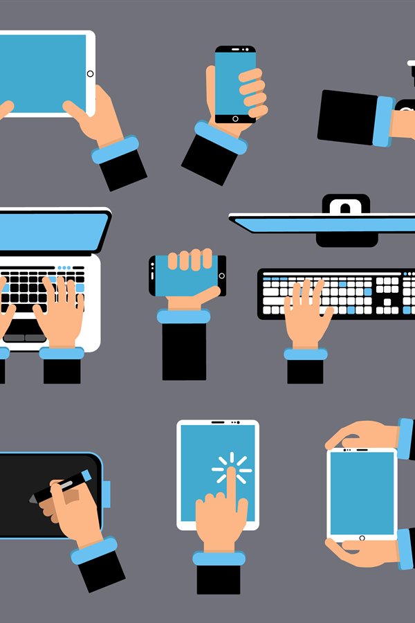 Hands holding different computer devices. Laptop, smartphone