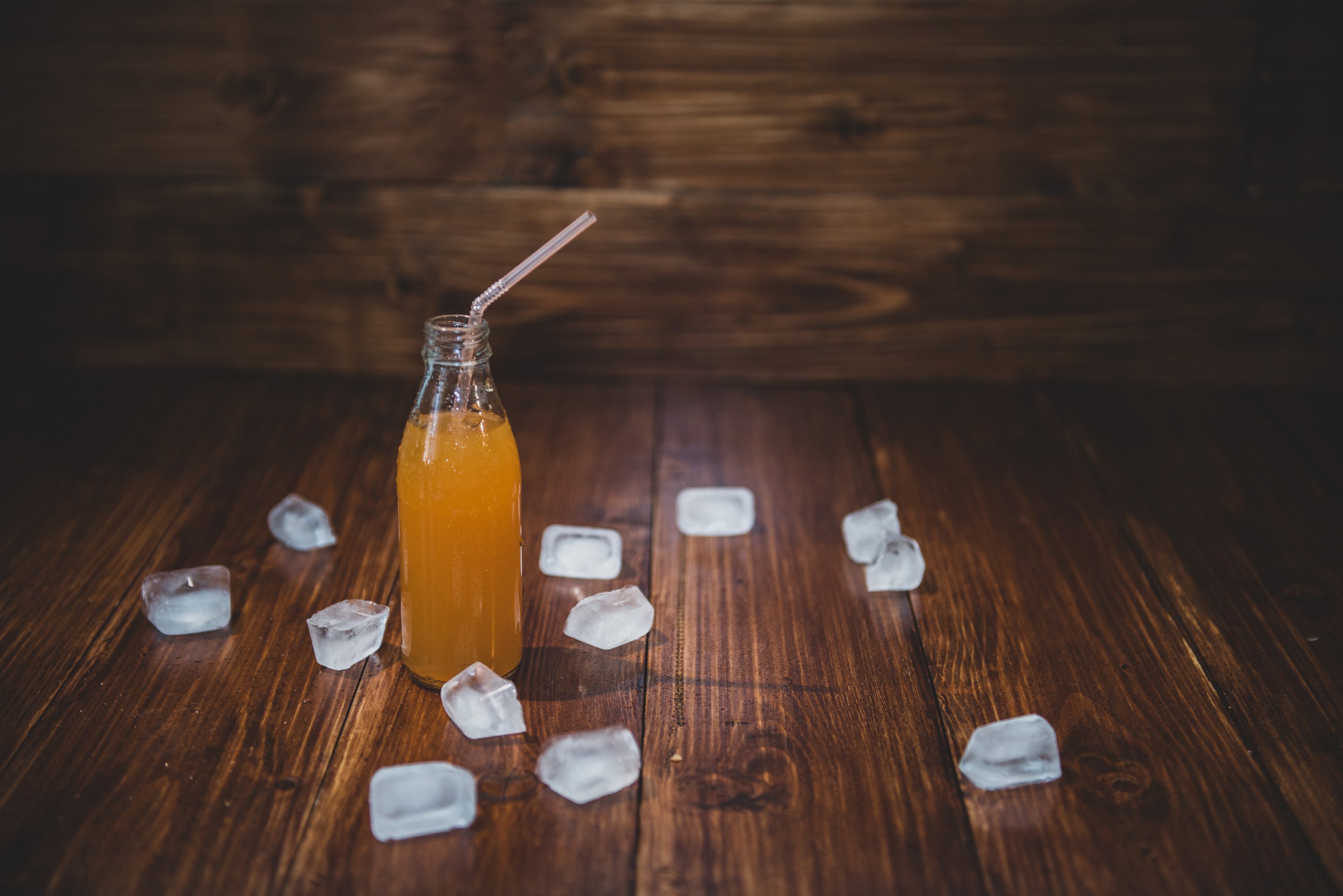 Ice fresh juice with ice cubes on table