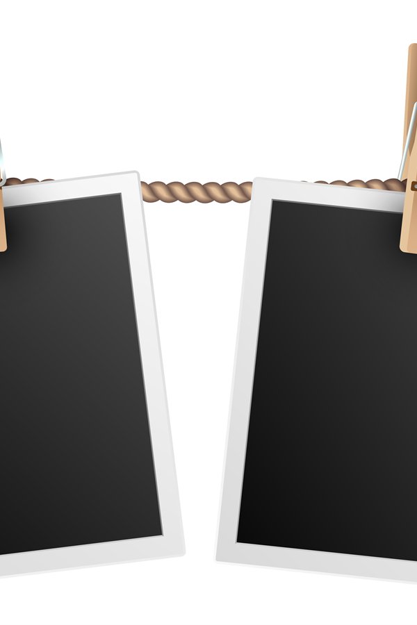 Retro photo frames hanging on rope isolated on (1180761)