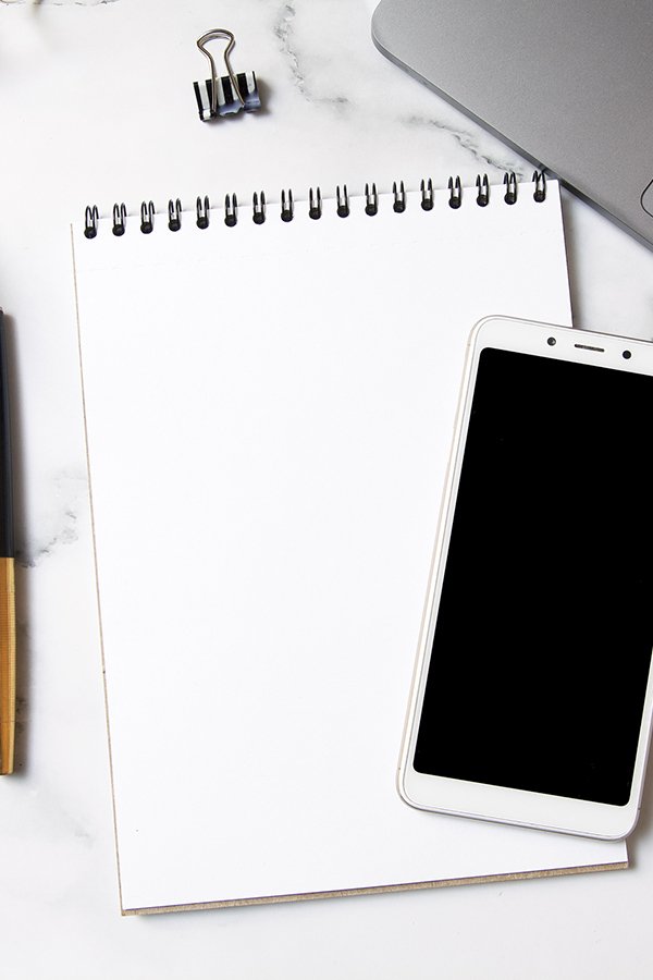 Top view workspace with a notebook mock-up, smartphone