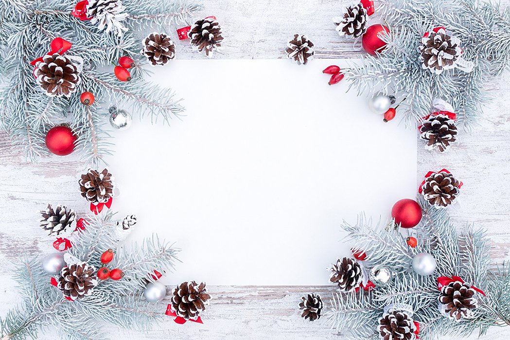 Christmas frame with snowed spruce twigs and scarlet decor
