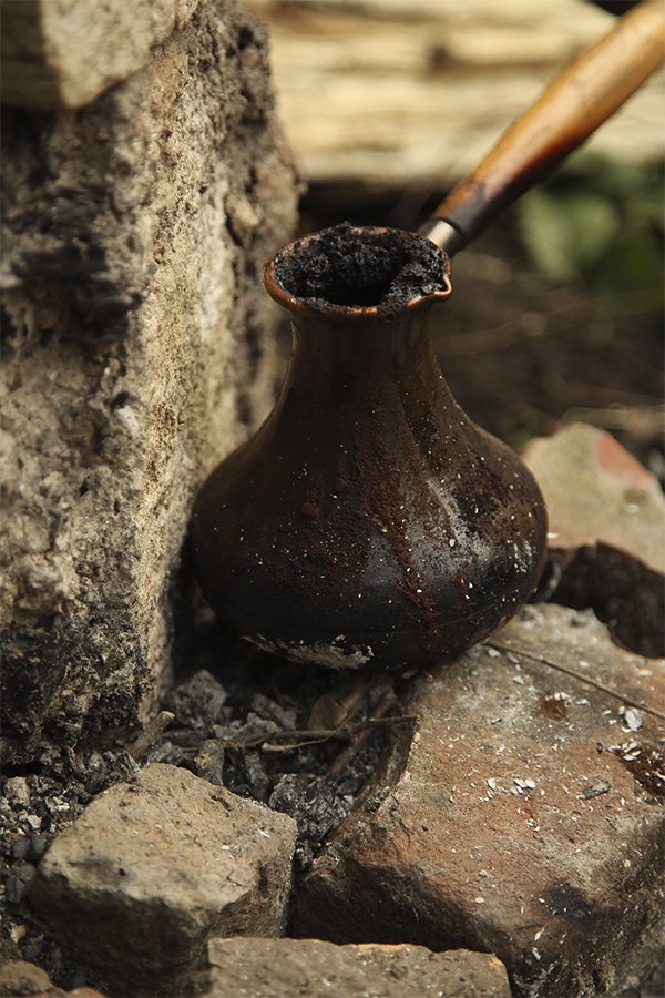 Beautiful Cezve for brewing coffee standing on stones