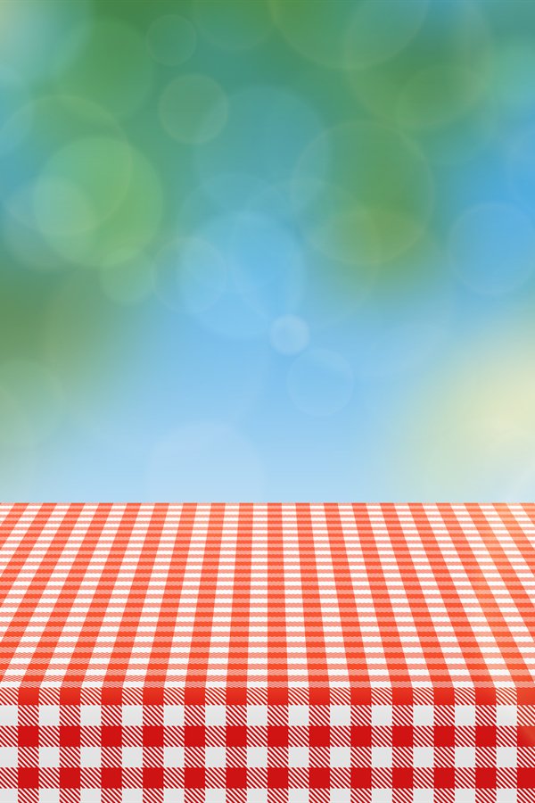 Picnic table with red checkered pattern of linen tablecloth