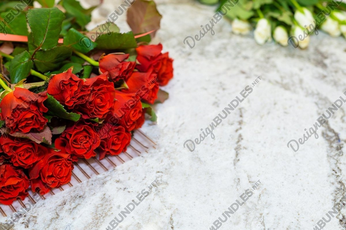 Photo of a bouquet of red roses on a white marble background