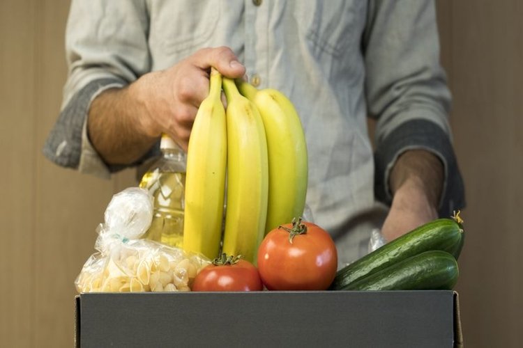 Man with box of food (583726)