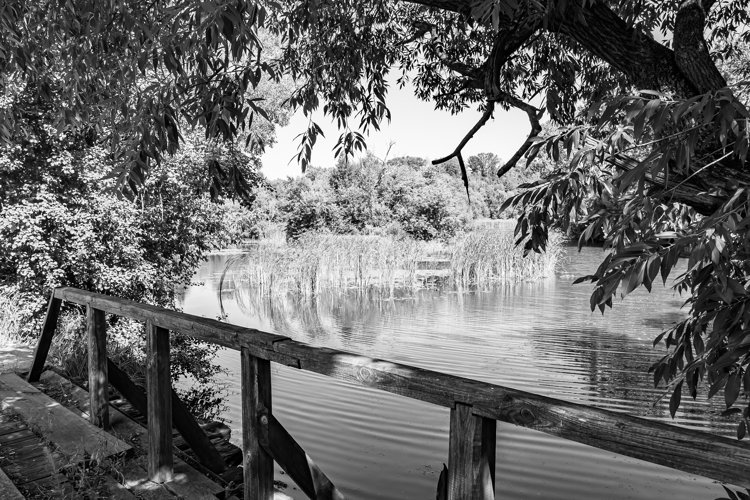 Beautifully standing old wooden bridge over river background