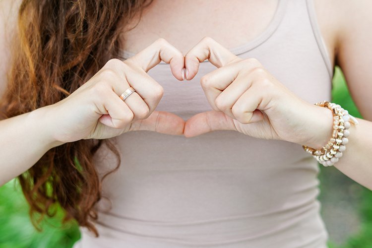 Woman Holding Heart Shaped Hands. Showing Love Sign