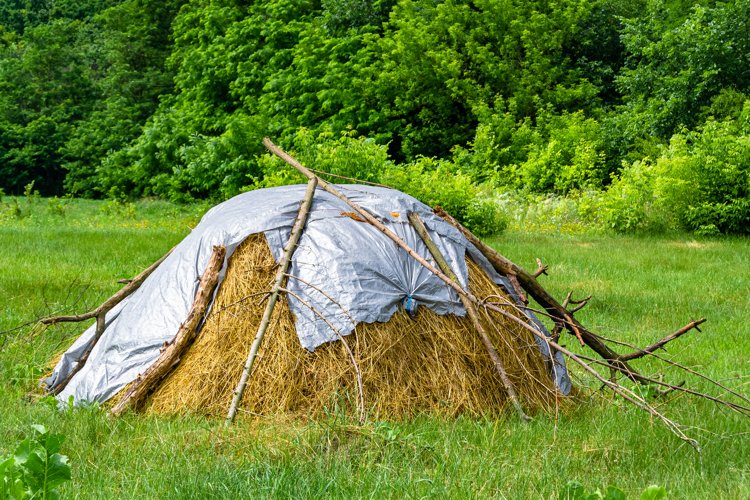 Photography on theme big dry haystack in grass farm field