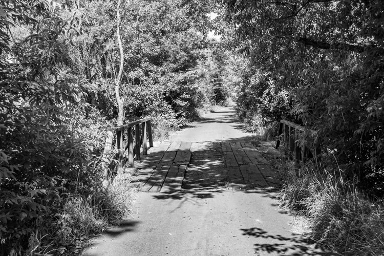 Beautifully standing old wooden bridge over river background