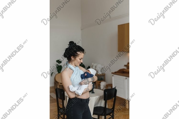 Caucasian woman cradles her African-American mestizo baby.