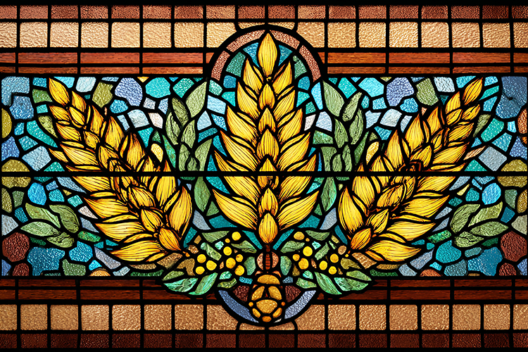 A vibrant stained glass window with wheat and leaves