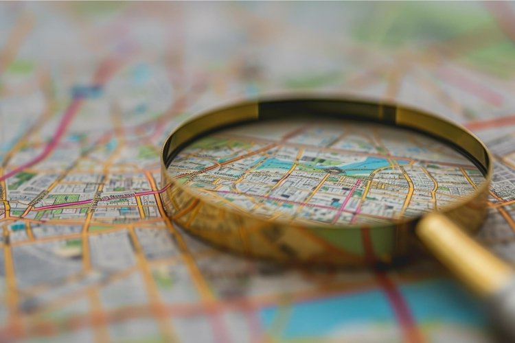 Close-up of magnifying glass on city map