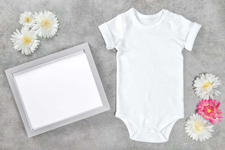 Baby bodysuit picture frame mock up flowers stock photo