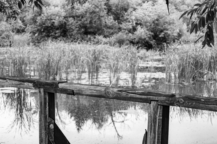 Beautifully standing old wooden bridge over river background