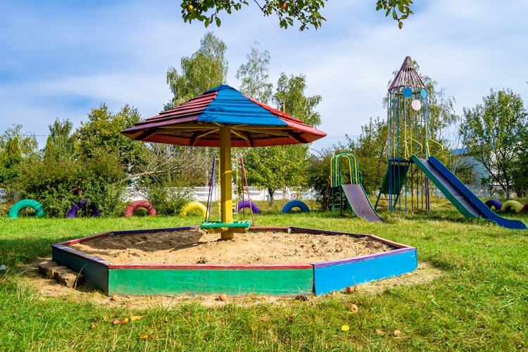 Empty wooden sandbox with sand for kids on playground