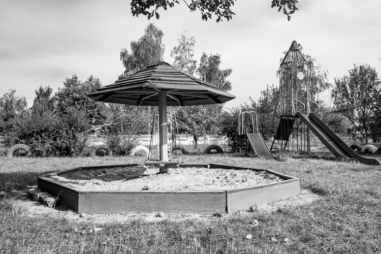 Empty wooden sandbox with sand for kids on playground