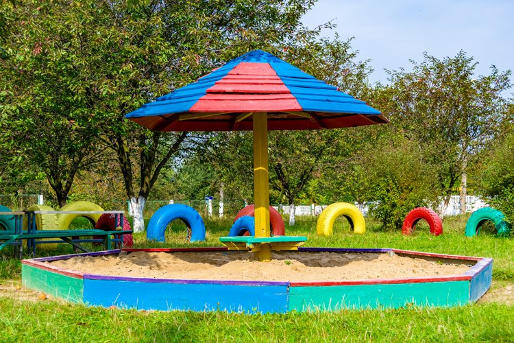 Empty wooden sandbox with sand for kids on playground