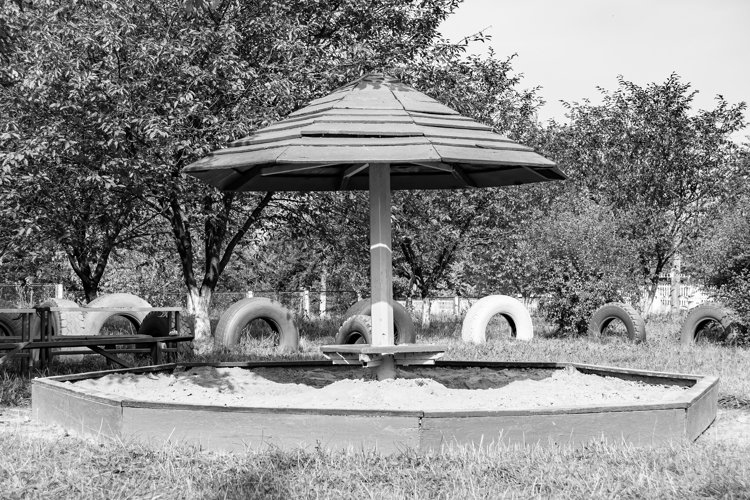 Empty wooden sandbox with sand for kids on playground