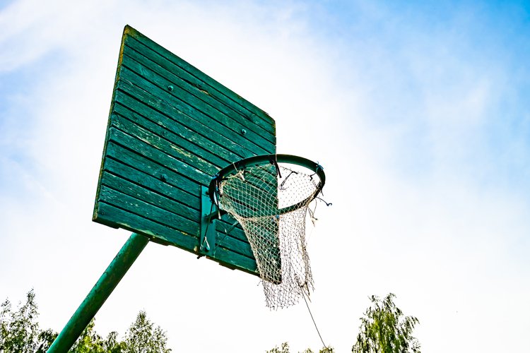 Old basketball hoop of net basket on background natural sky