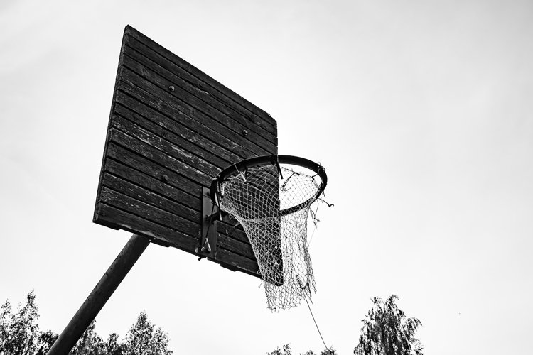 Old basketball hoop of net basket on background natural sky
