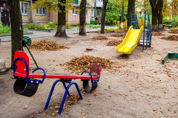 Empty playground with metal slide for kids on nature