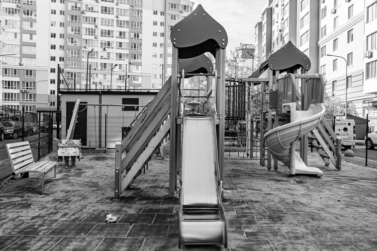 Empty playground with metal slide for kids on nature