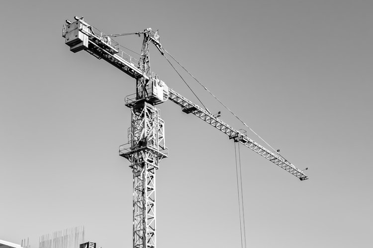 Big steel crane on construction site of residential building