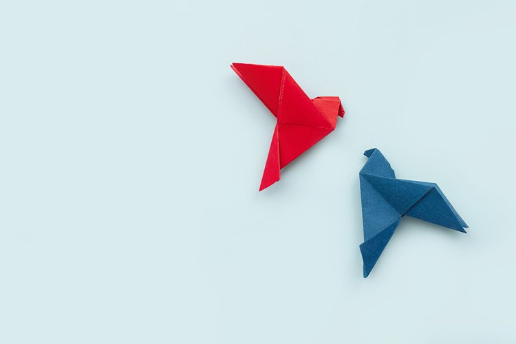 two doves made of origami paper in red and blue color